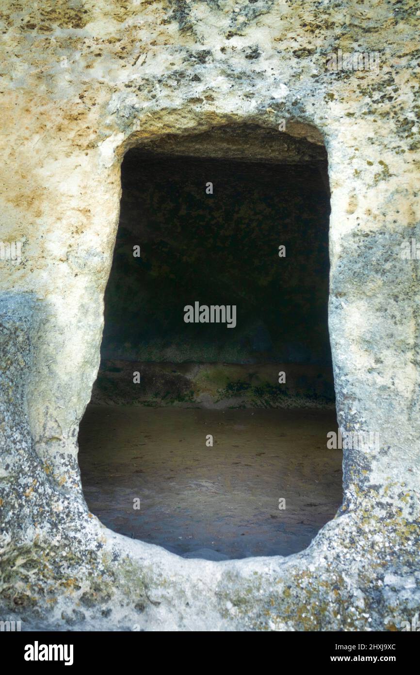 Entrance to a man-made cave in a limestone rock. A place of refuge for ...