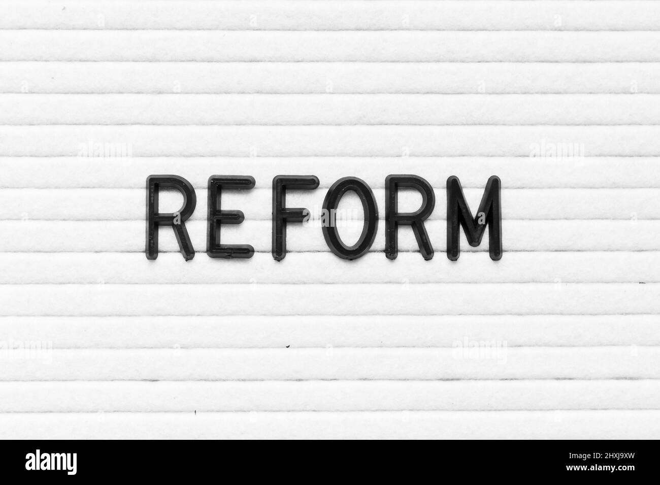 Black color letter in word reform on white felt board background Stock ...