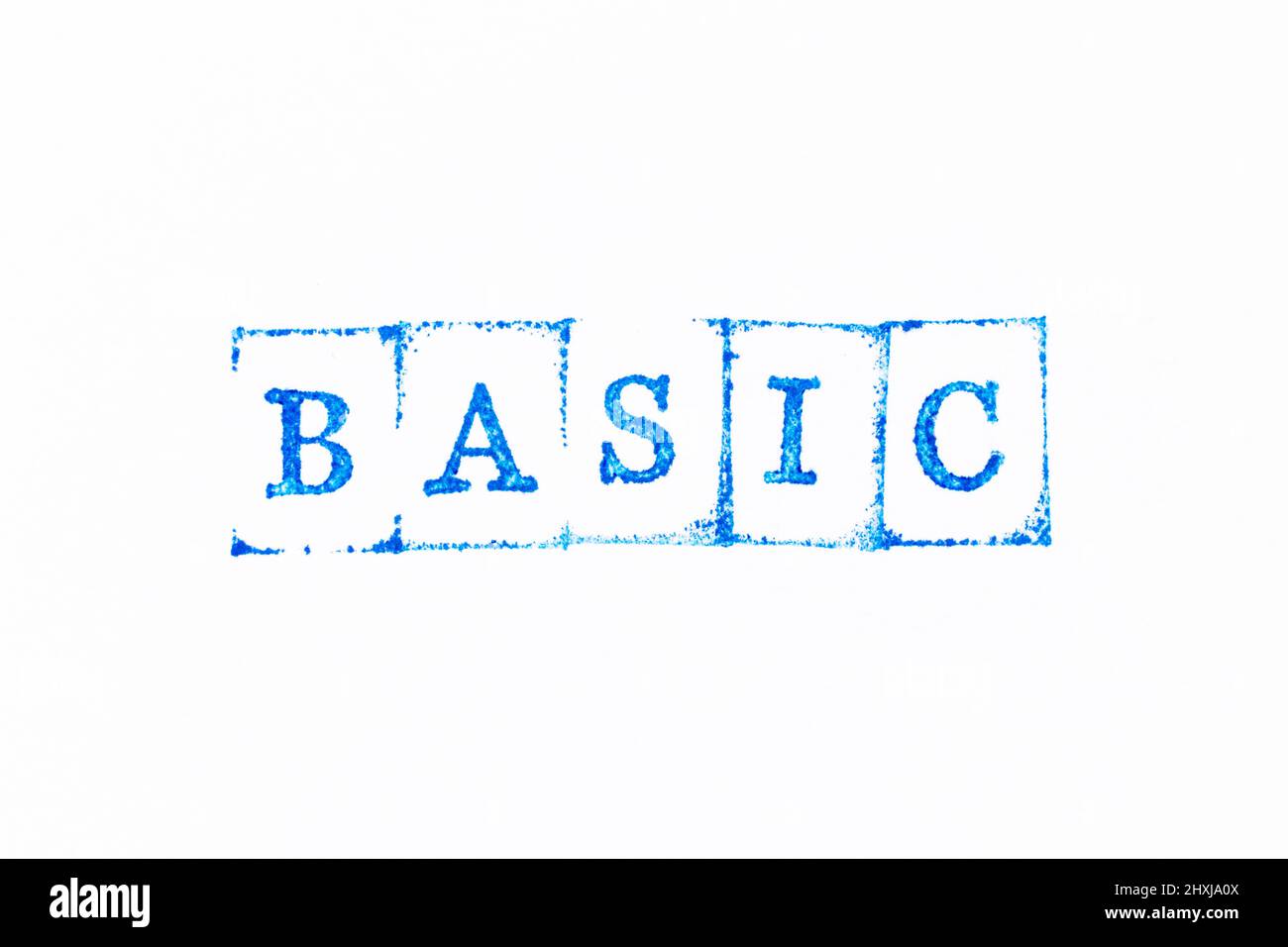 Blue color ink rubber stamp in word basic on white paper background ...