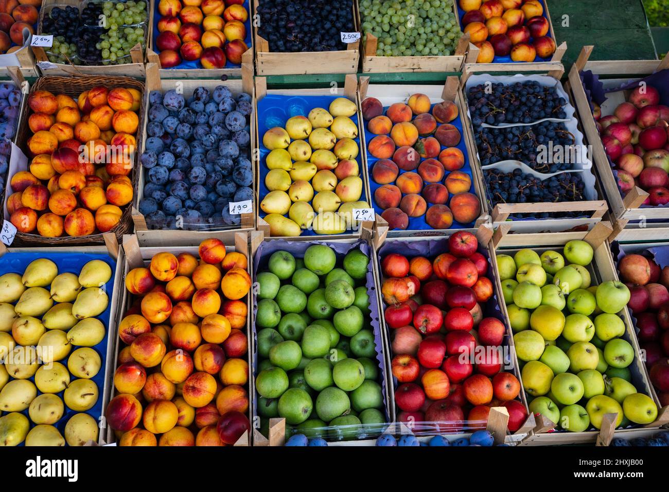 Top view of boxes with a wide variety of fruit in a market street shop ...