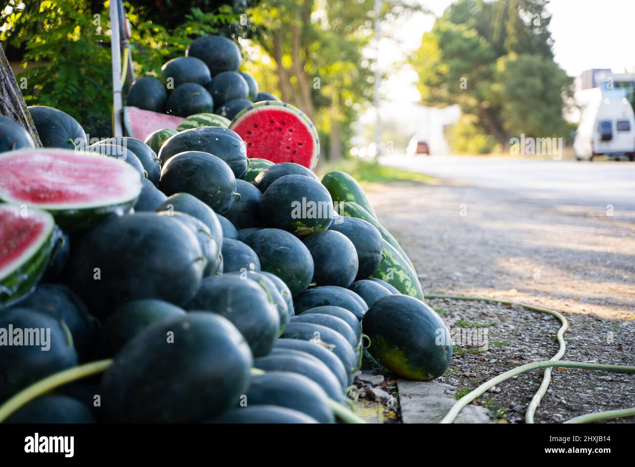 Pile of watermelon on a street stall next to a road. Montenegro Stock ...