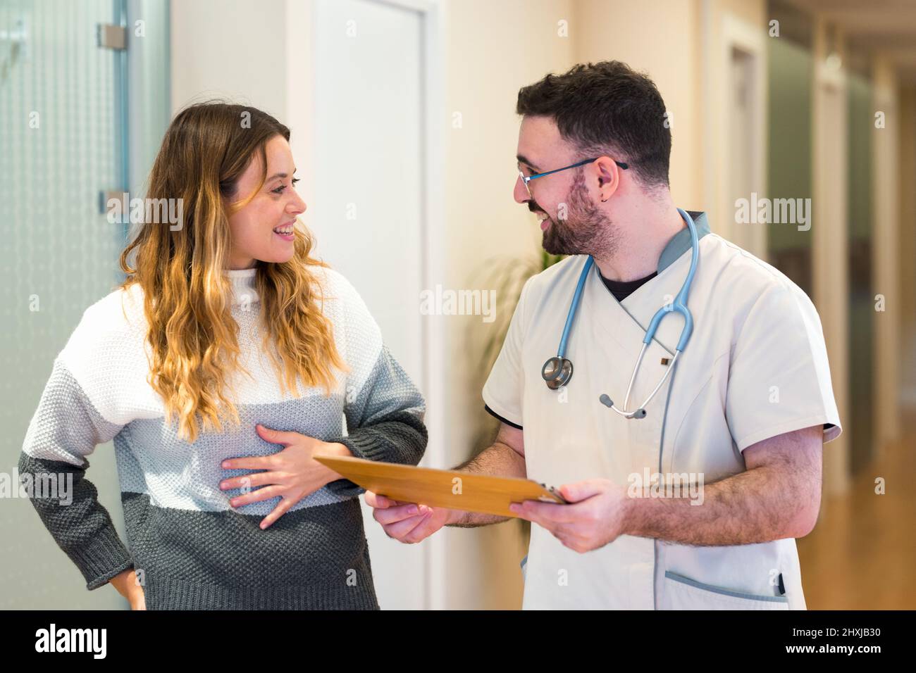 Male doctor giving instructions and explaining something to his patient ...