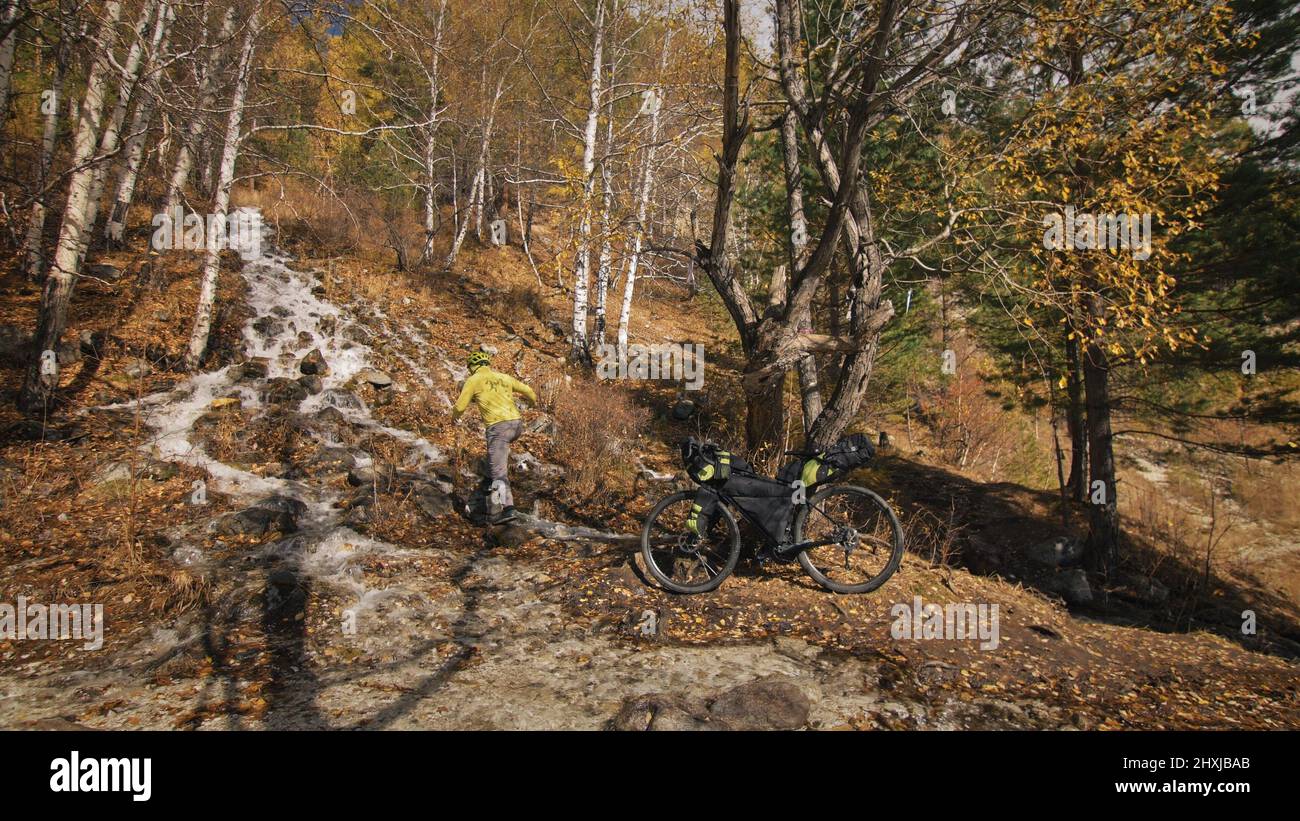 The man travel on mixed terrain cycle touring with bikepacking. The ...