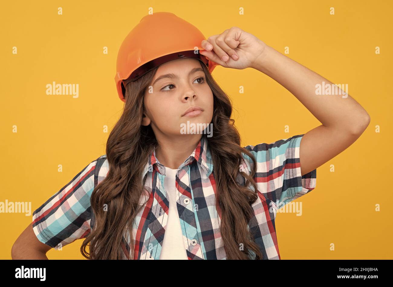 serious girl in protective hard hat. child wear helmet for building ...
