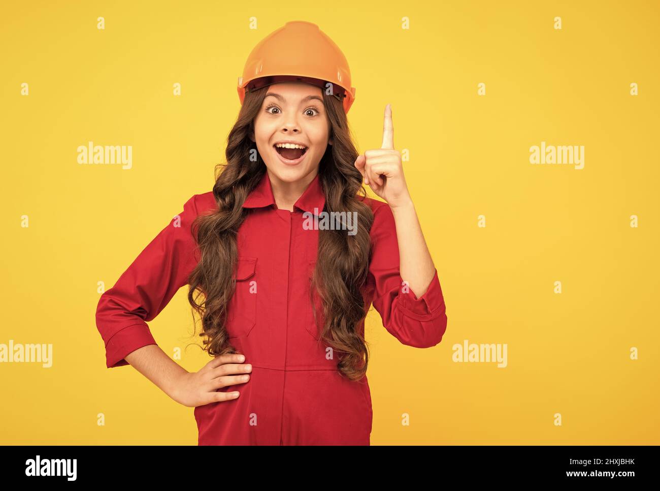 happy kid girl in protective helmet raised finger with idea ...
