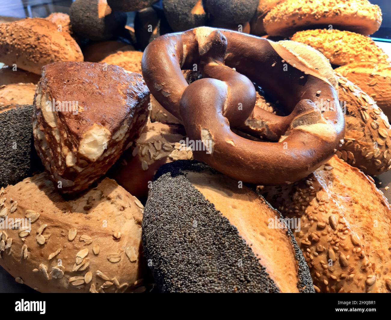 Bread rolls in a bakery display as a symbol for diversity in the range ...