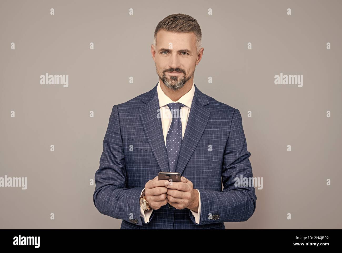 confident businessman man in suit typing text message on phone ...