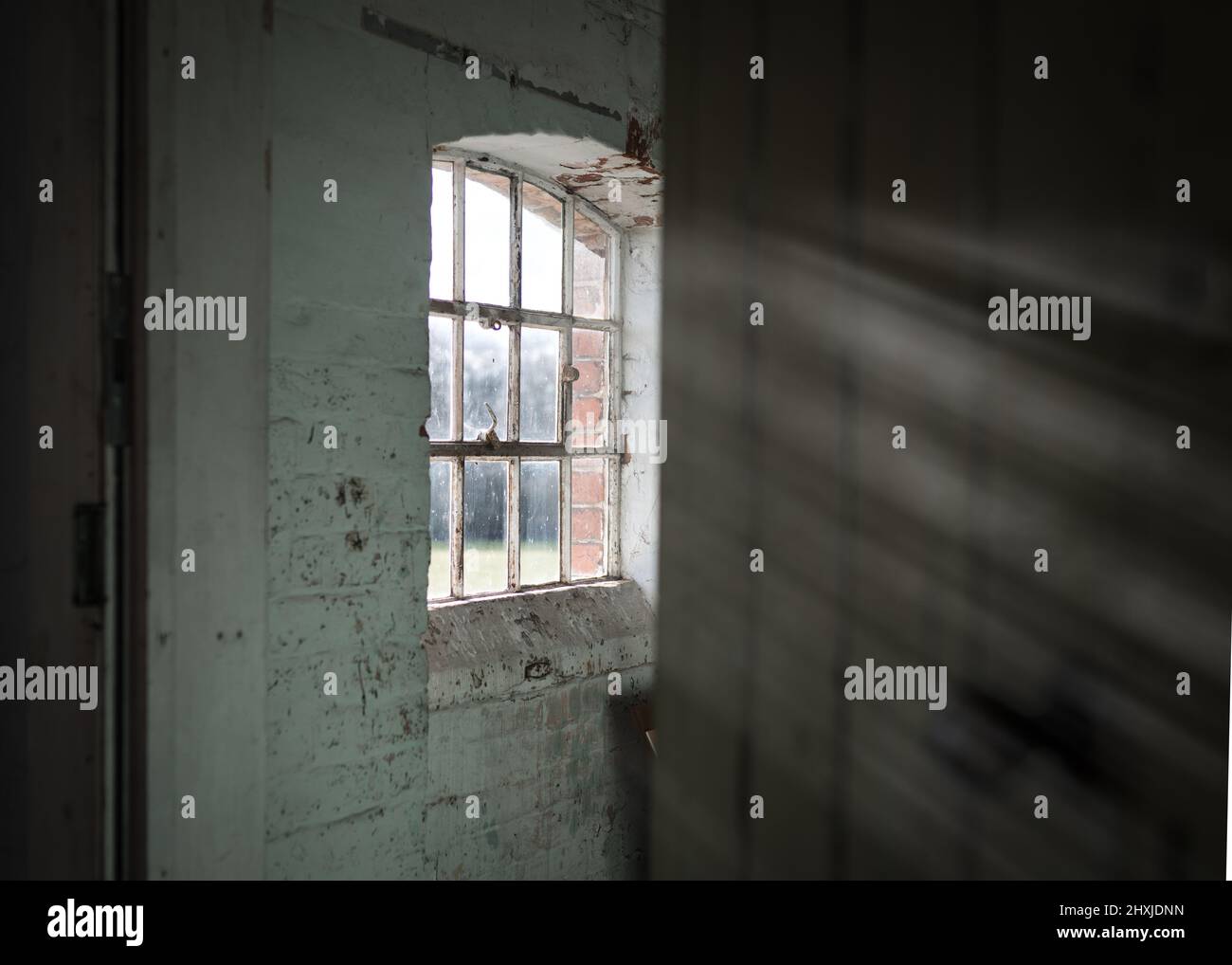 Dark and creepy wooden cellar window in abandoned workhouse viewed ...