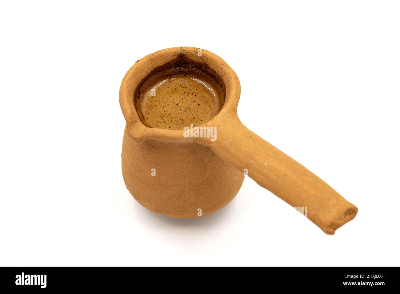 Turkish coffee in a clay pot isolated on a white background ...
