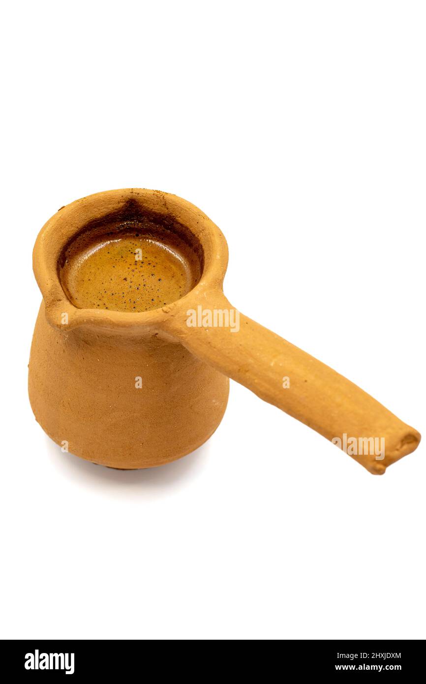 Turkish coffee in a clay pot isolated on a white background ...