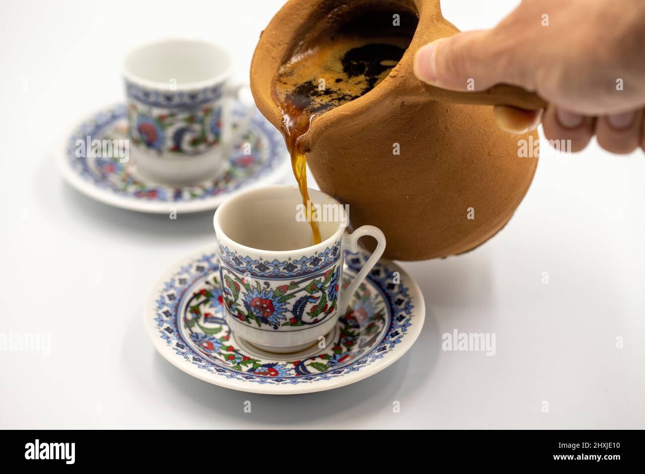 Turkish coffee in a clay pot on a white background. Traditional Turkish ...