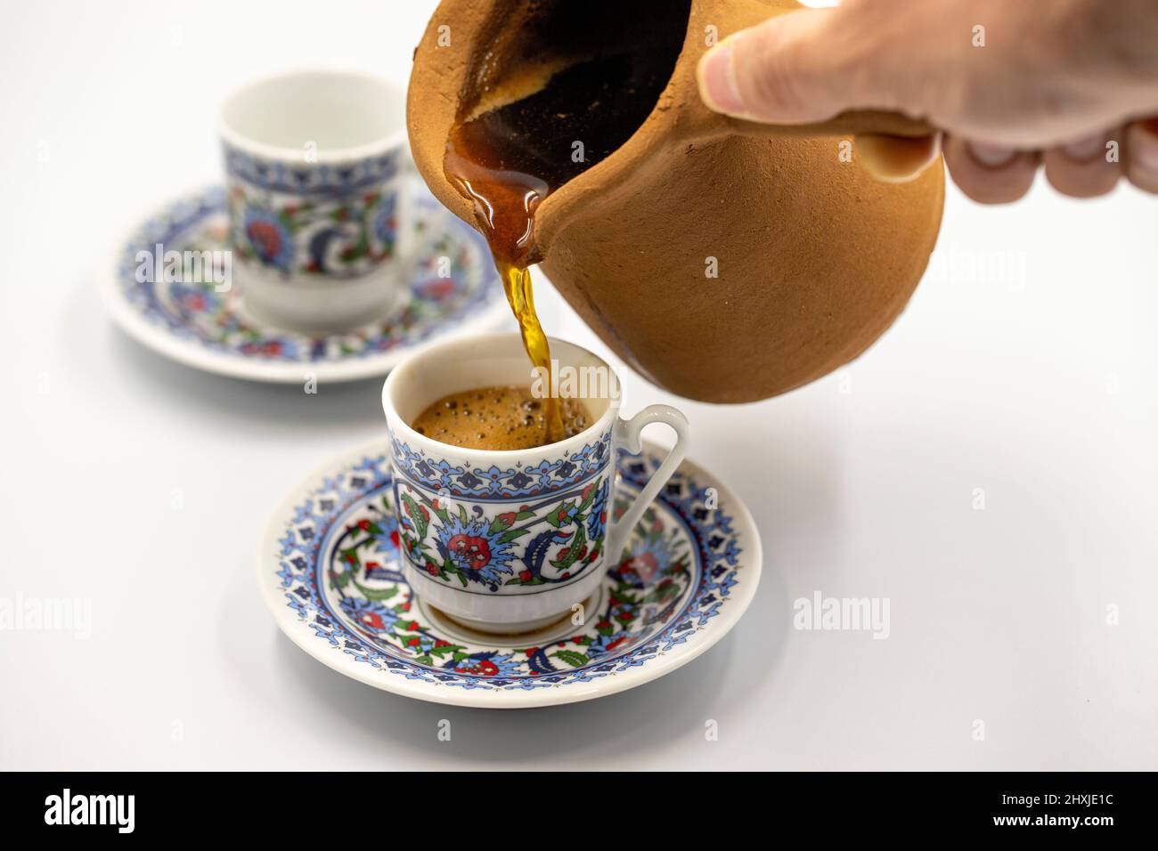 Turkish coffee in a clay pot on a white background. Traditional Turkish ...