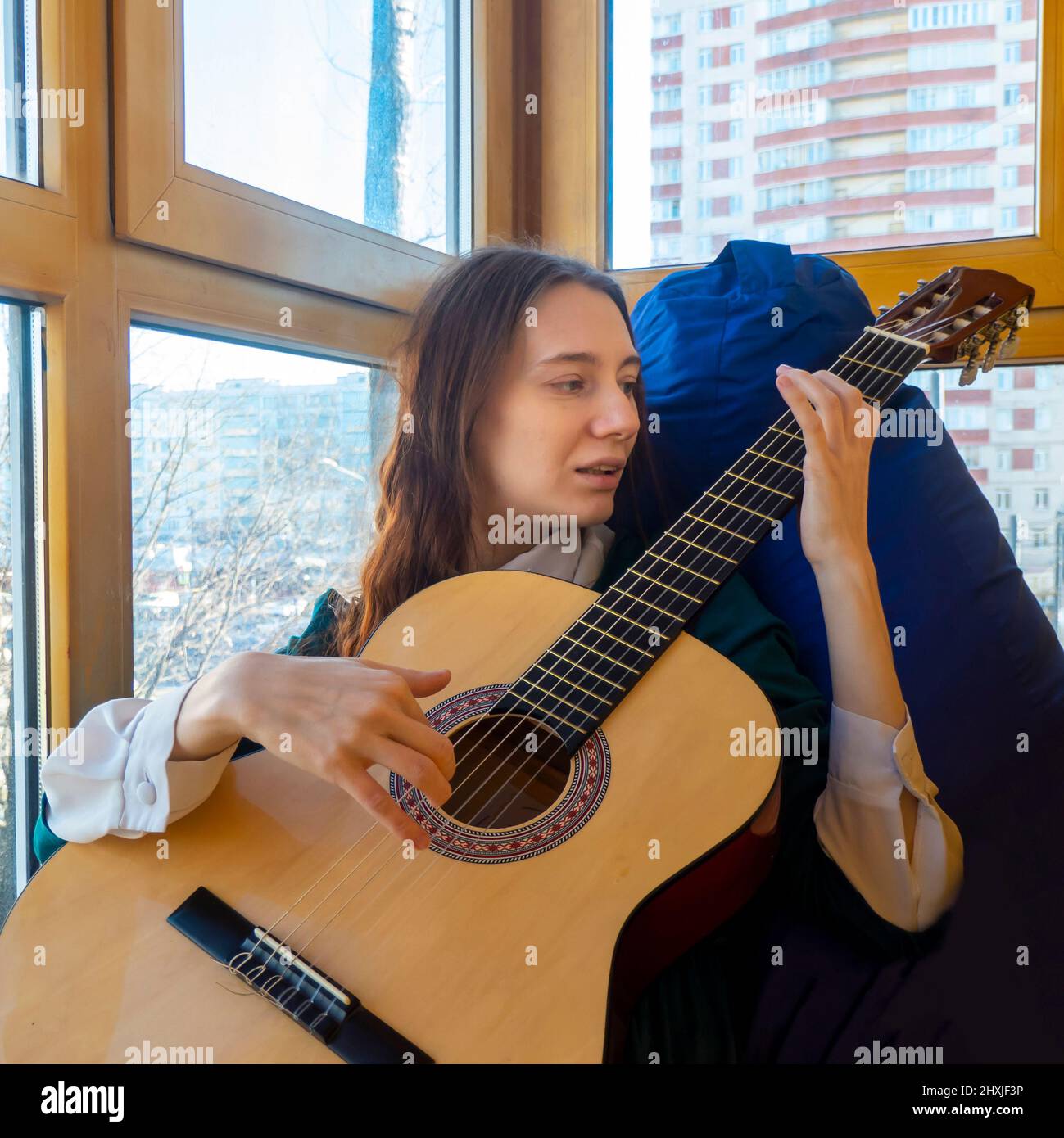 young woman playing classical guitar on the balcony Stock Photo - Alamy
