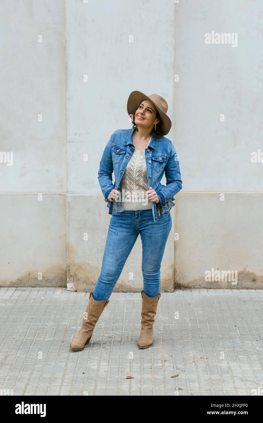 Tourist woman looking around and posing while taking a walk outdoors ...