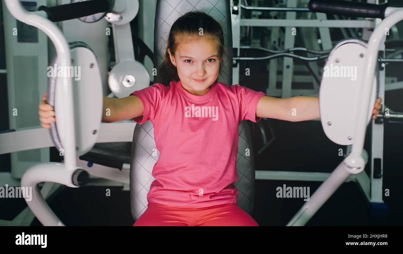 Fit Athletic Baby Girl Work out in Butterfly Pectoral Machine for Chest ...