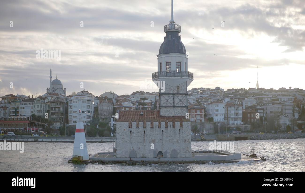 Old tower on small island in background of city. Action. Beautiful ...