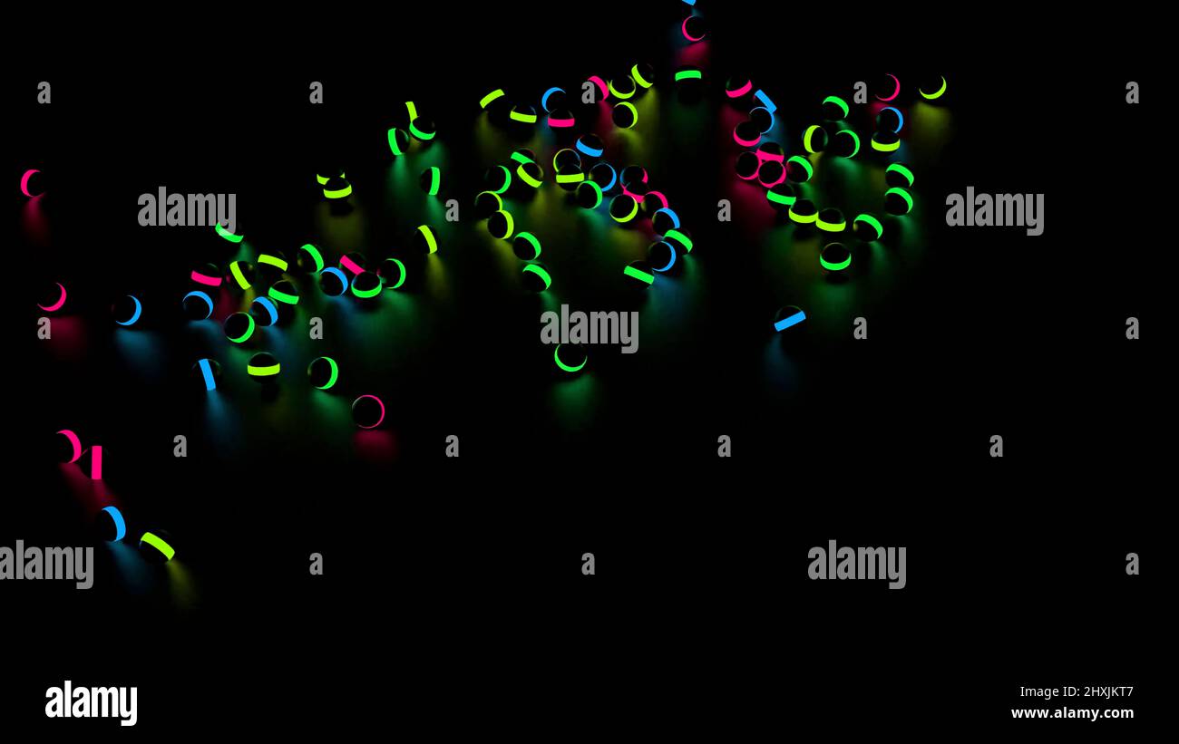 Colorful shining balls falling and rolling on a black background ...