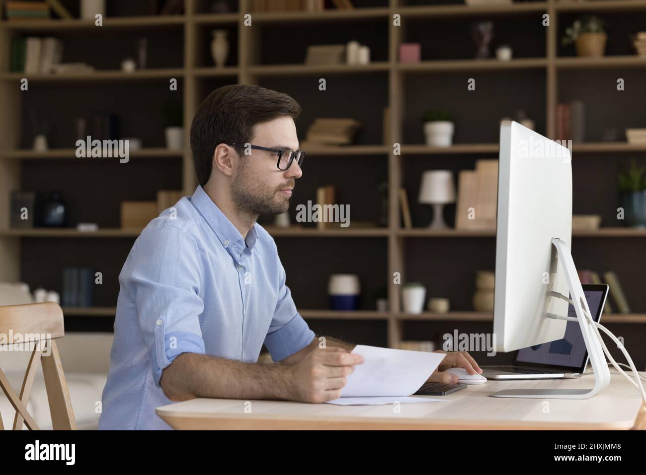 Busy male manager analyze financial documents at workplace using ...
