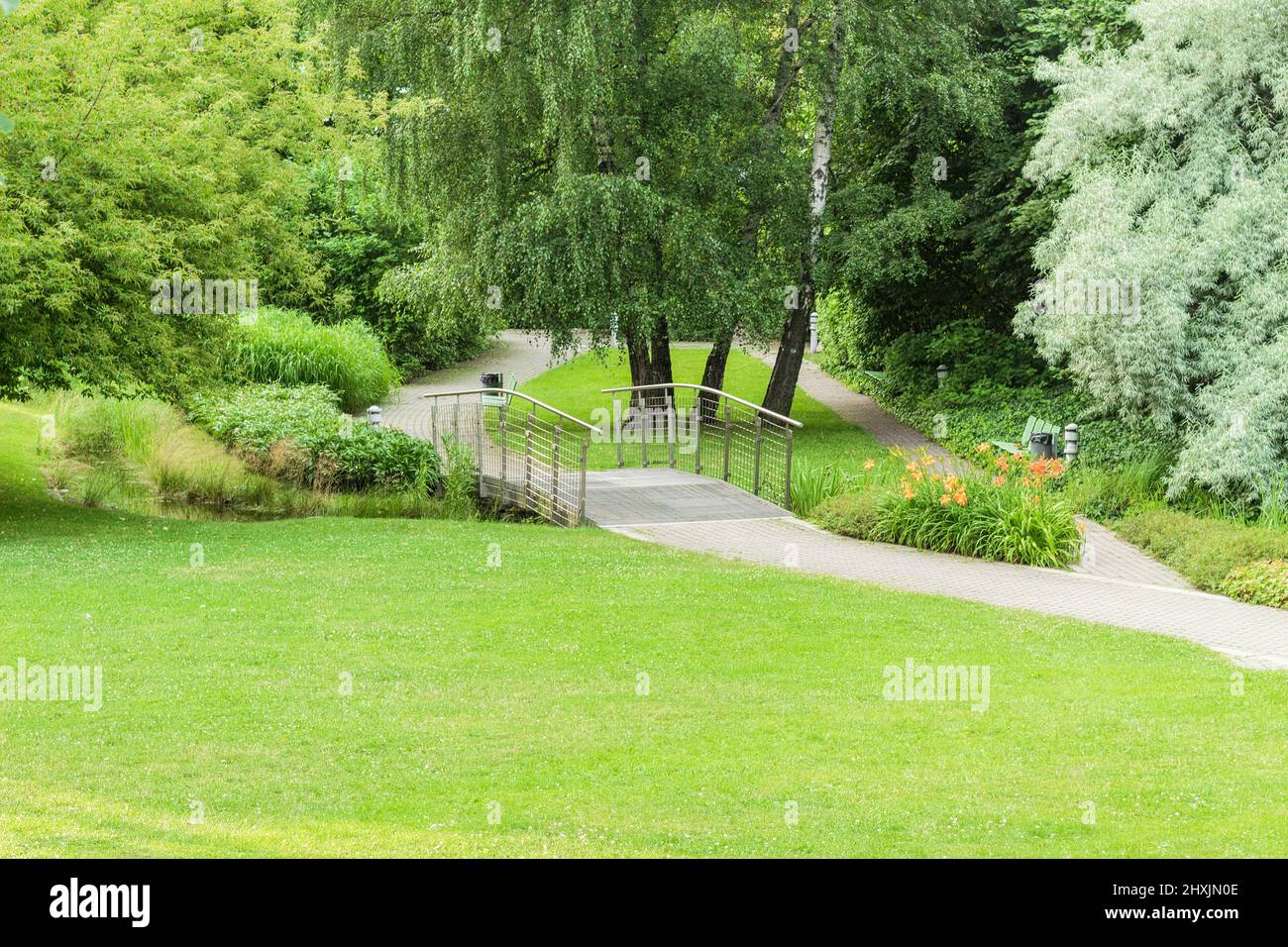 Beautiful and neat path in the city park, landscape. Alley and sidewalk ...
