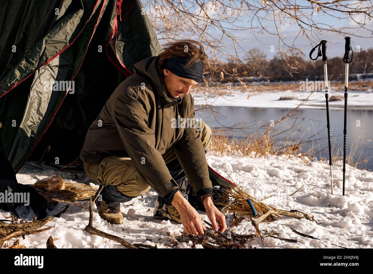 Man starts a fire in forest. Lighting a fire in nature, forest by male ...