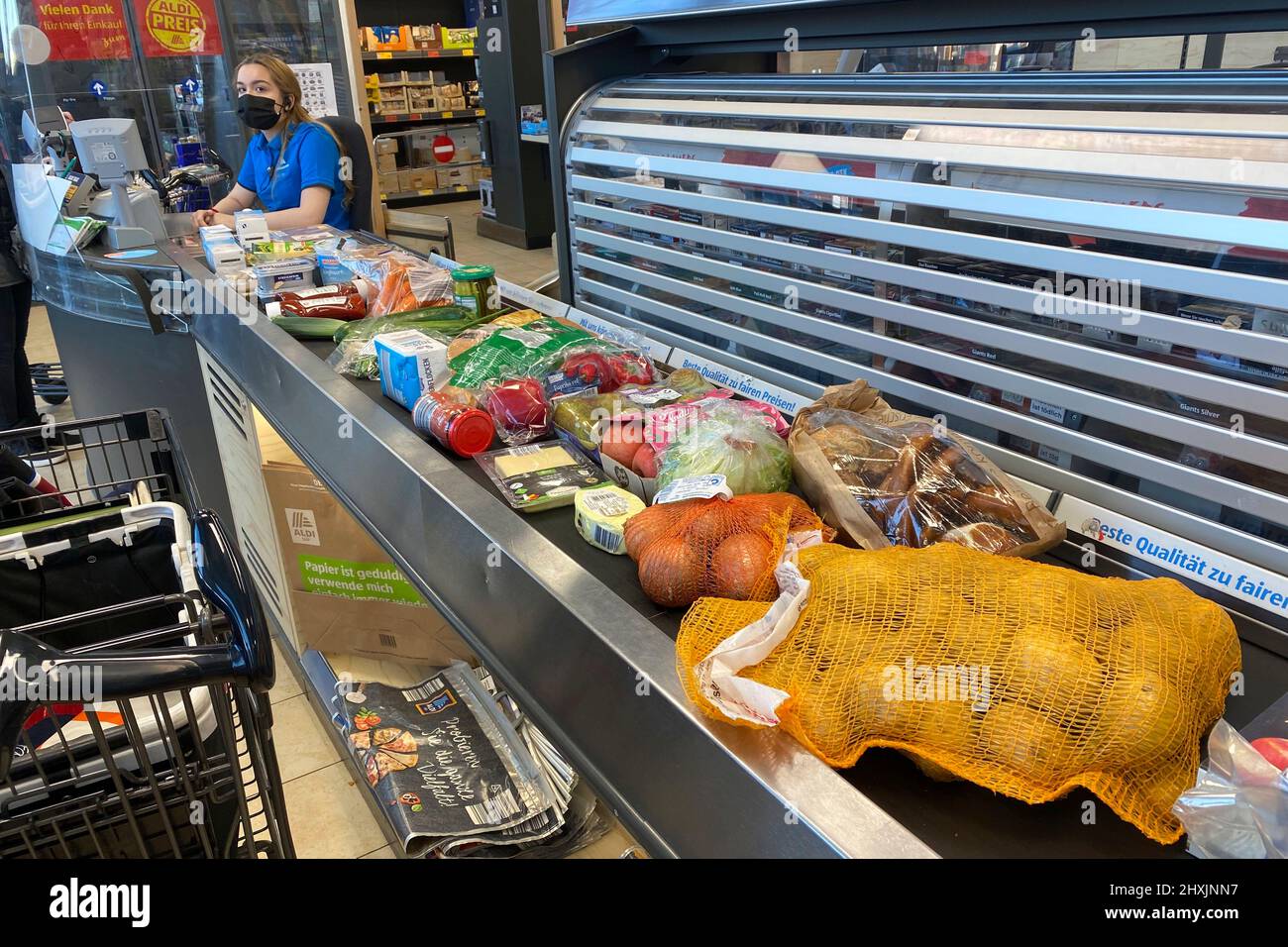 Goods, goods, foodstuffs lie on a checkout belt at a supermarket ...