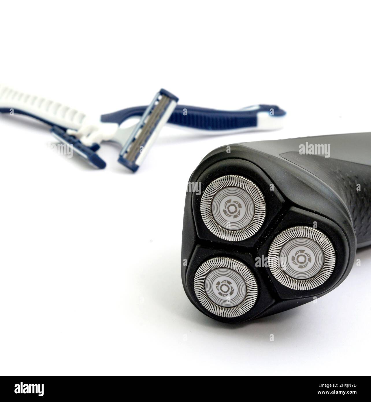 New Electric shaver and razor blades on white Stock Photo - Alamy