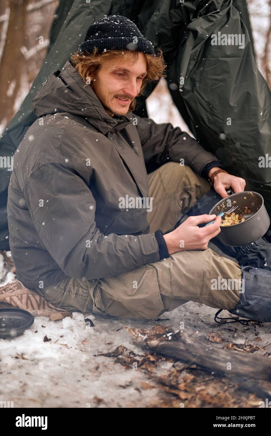 caucasian lonely man sitting by campfire alone spending happy adventure ...