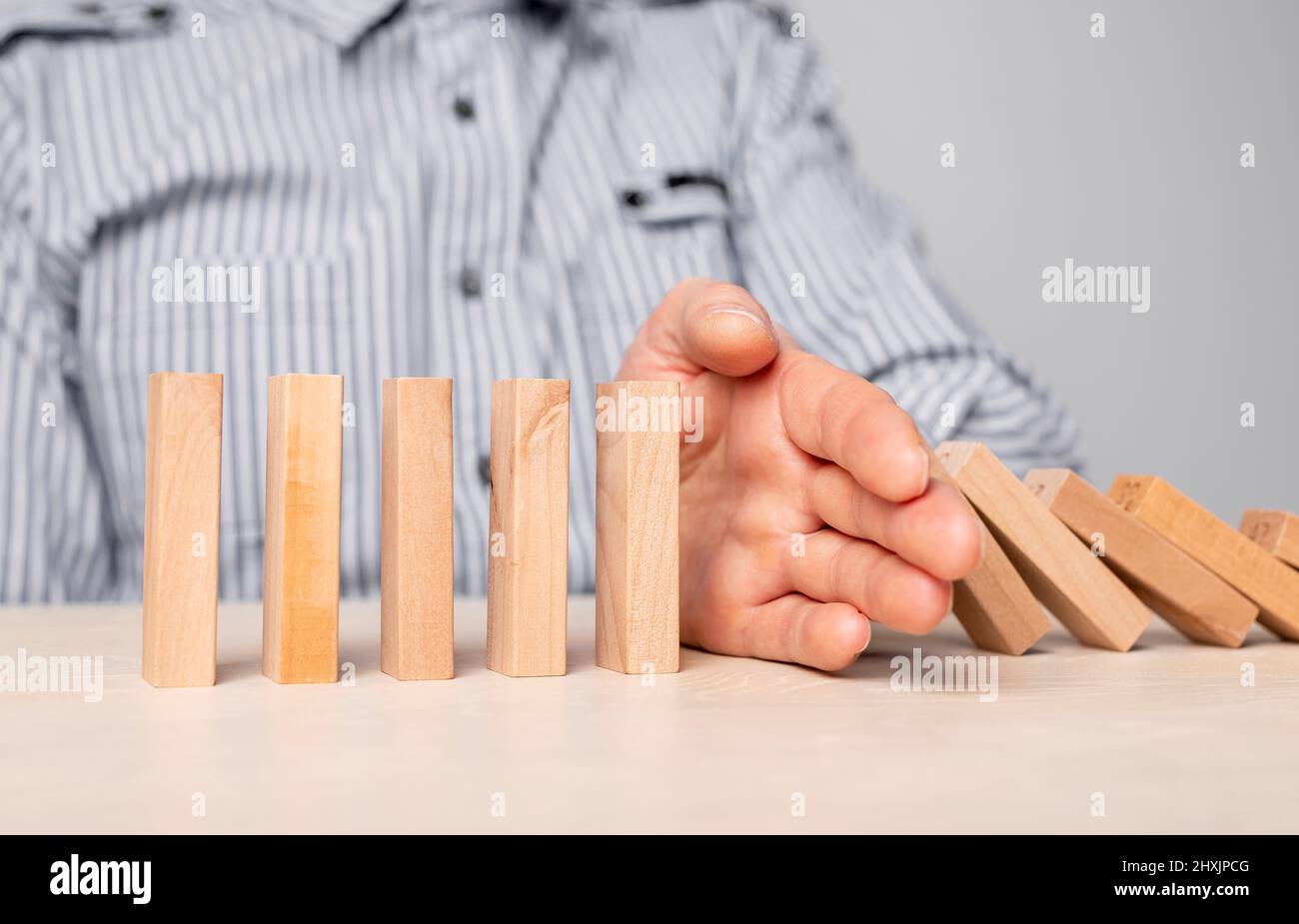 Business man protect falling blocks hi-res stock photography and images ...