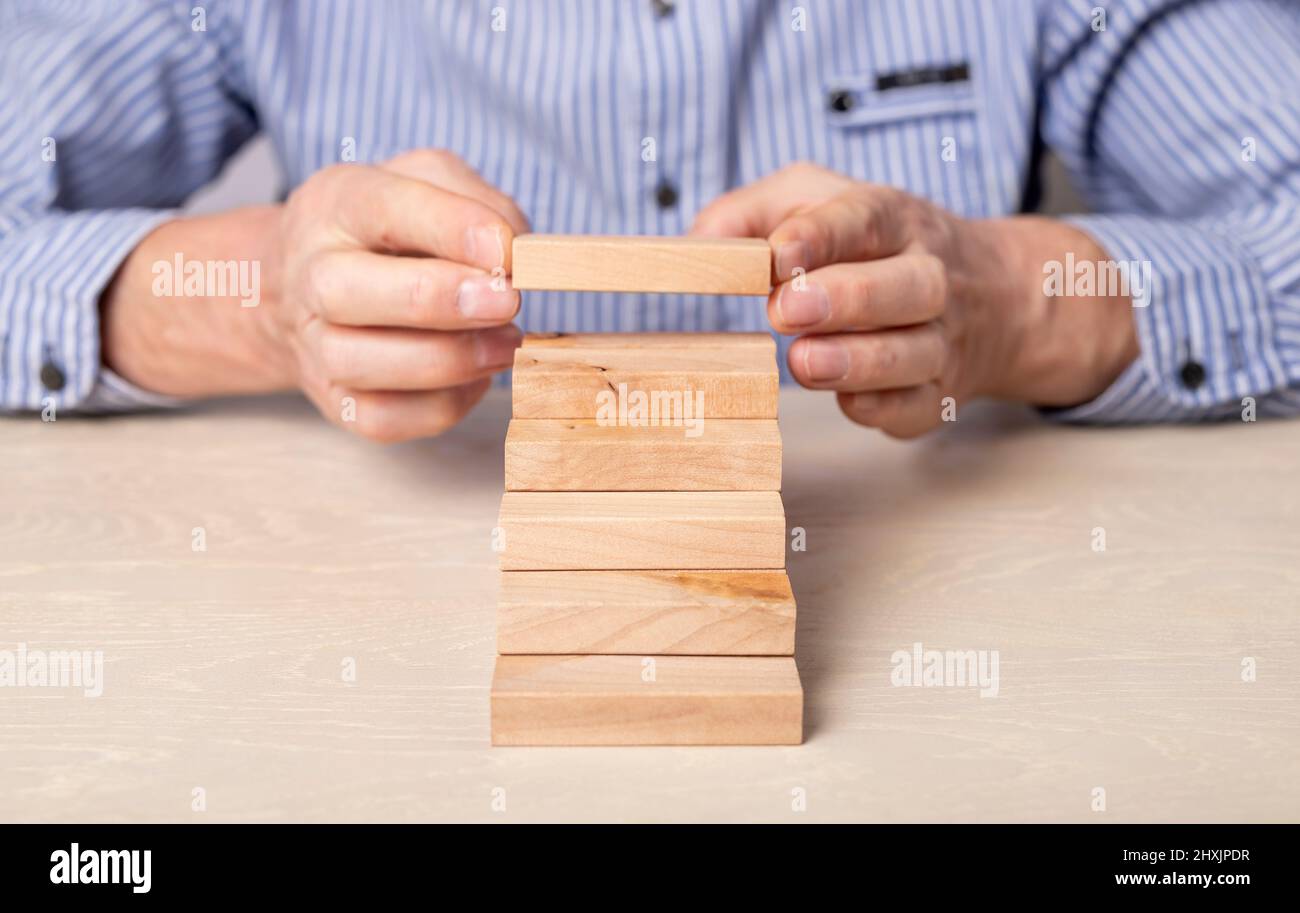 Career ladder concept. Wood blocks stairs arranged by businessman ...