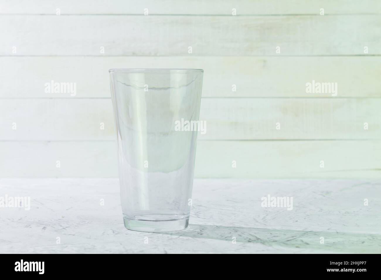 Empty glass beaker on a white background. Glassware and background with ...