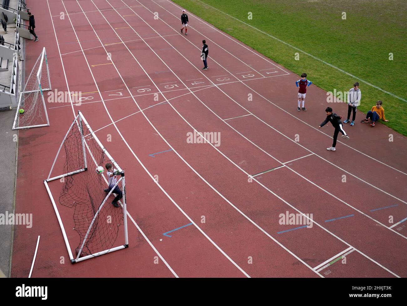 Kids play football at the London Marathon Community Track outside the ...