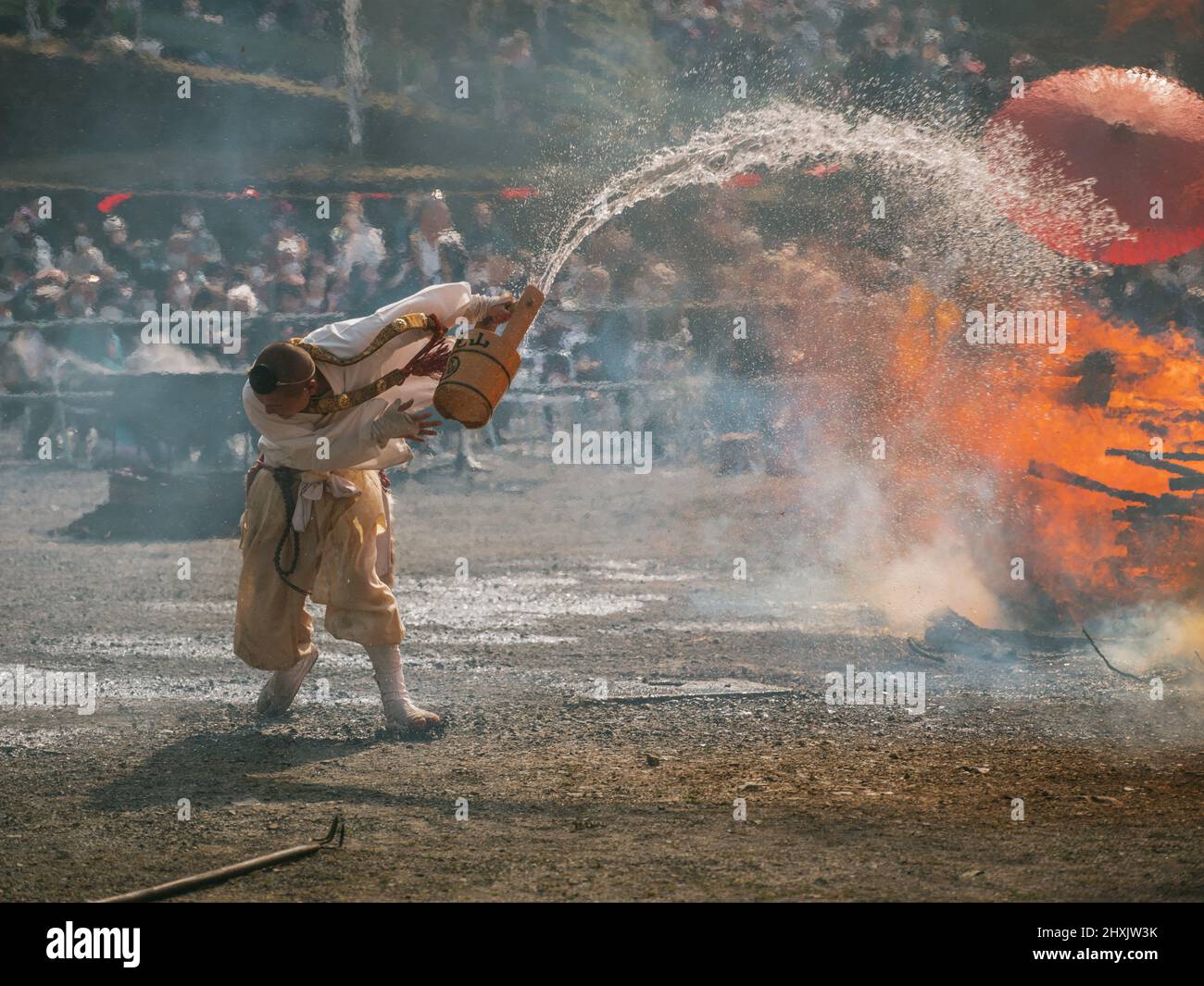 Tokyo, Japan. 13th Mar, 2022. A Yamabushi splashes water on bonfire ...