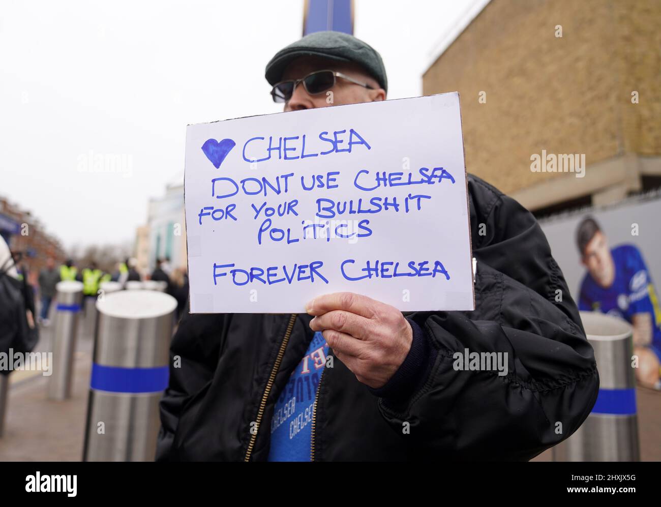 *EDITORS NOTE - LANGUAGE ON SIGN* A Chelsea fan holds up a sign outside ...