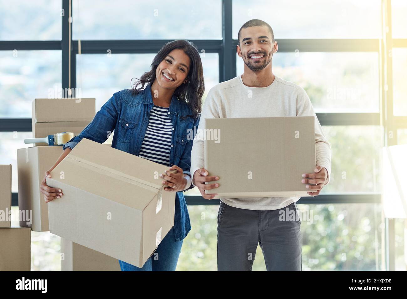 This is where our story begins. Portrait of a happy young couple moving ...