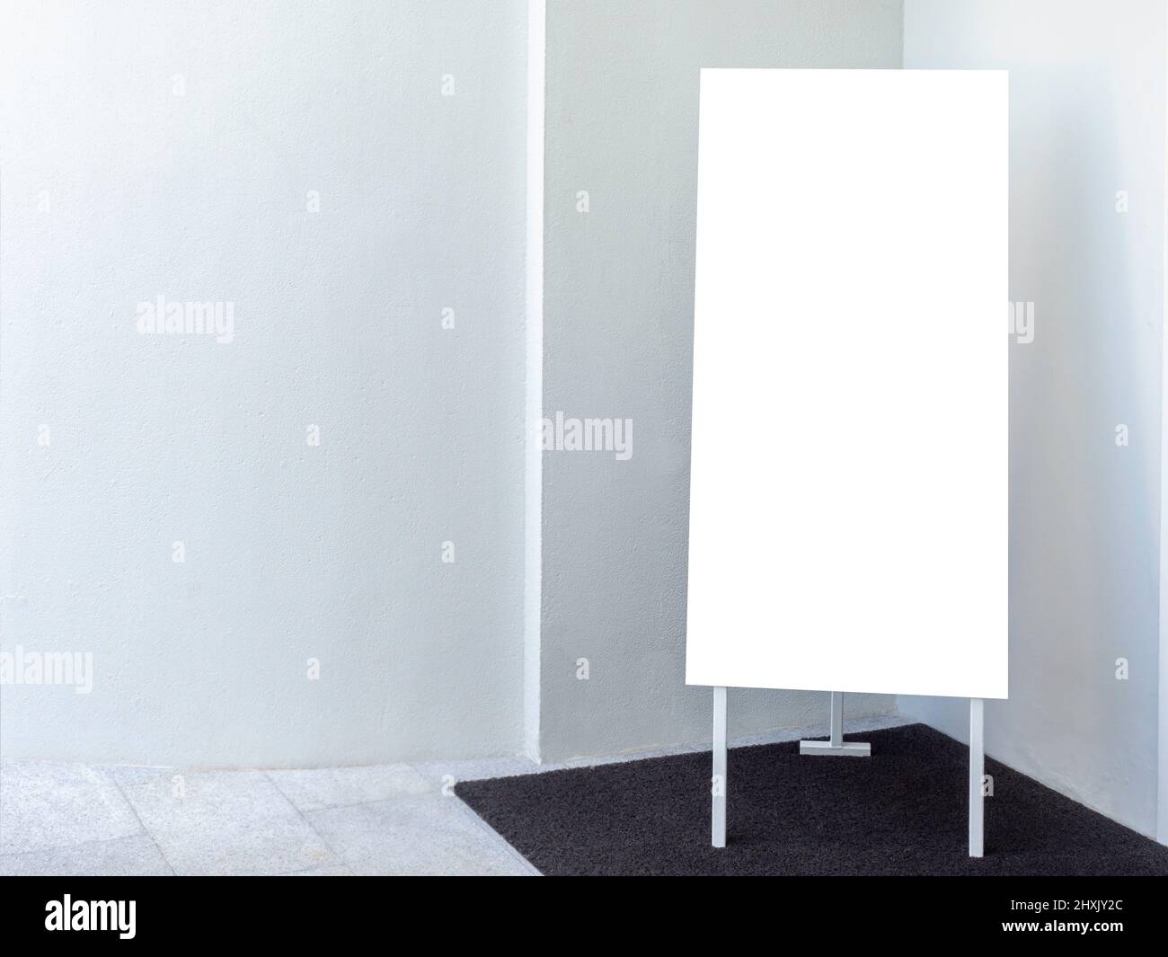 White blank display stand banner on white wall background with copy ...