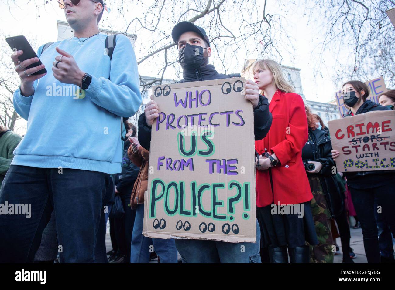 London, UK. 12th Mar, 2022. A protester holds a sign saying "who ...
