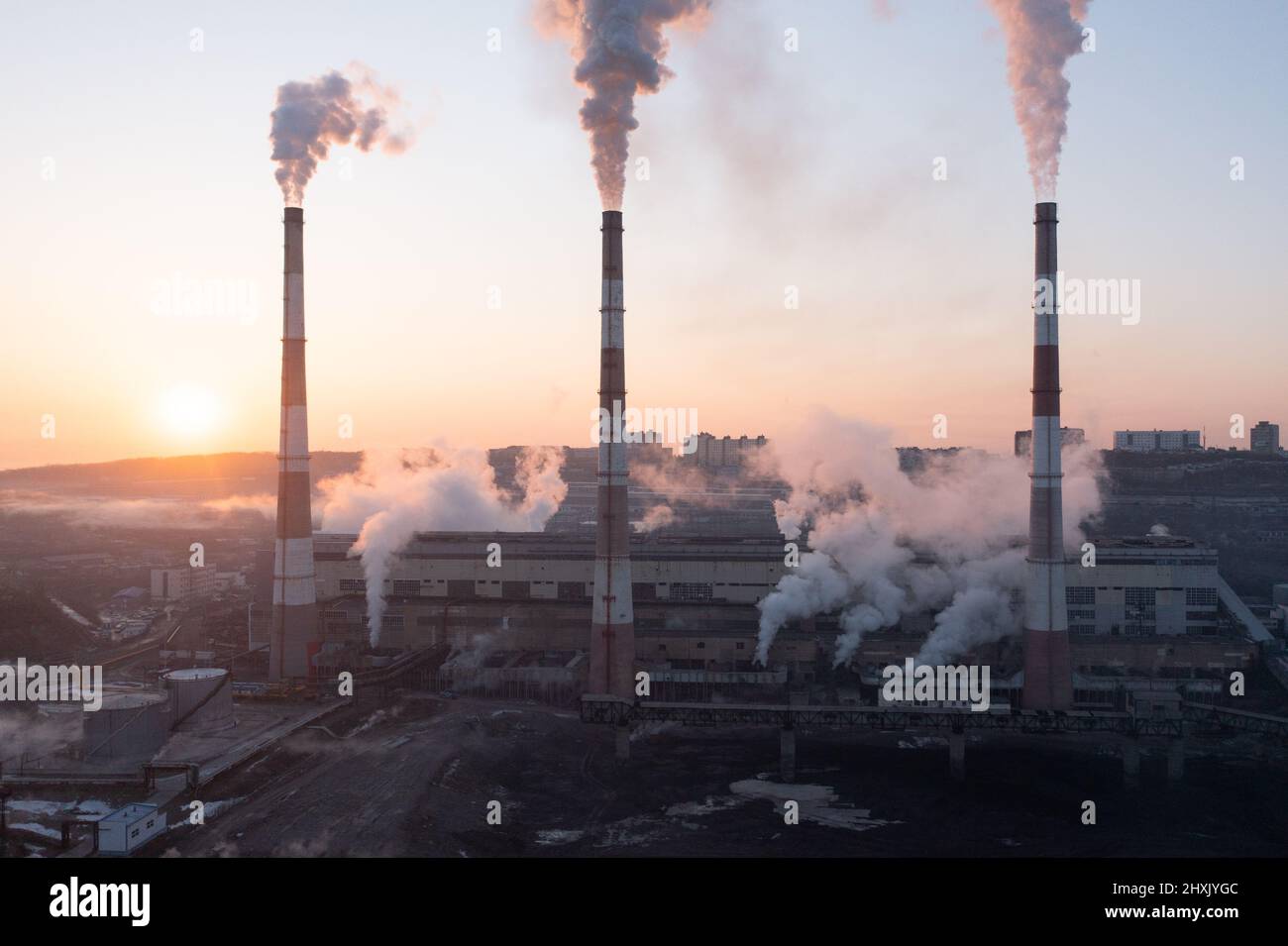 A working factory with chimneys billowing with smoke Stock Photo - Alamy