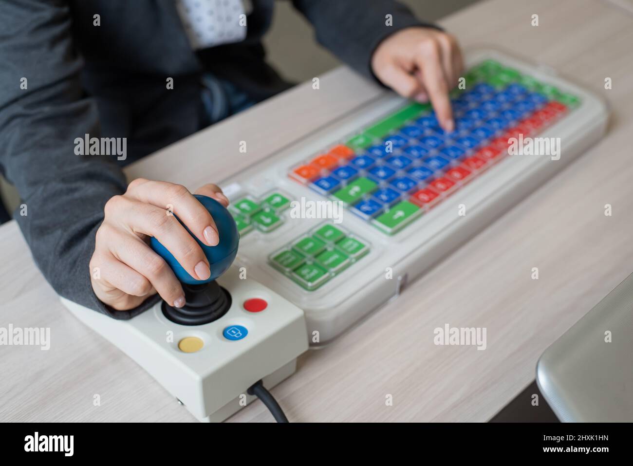 Woman with cerebral palsy works on a specialized computer mouse Stock ...