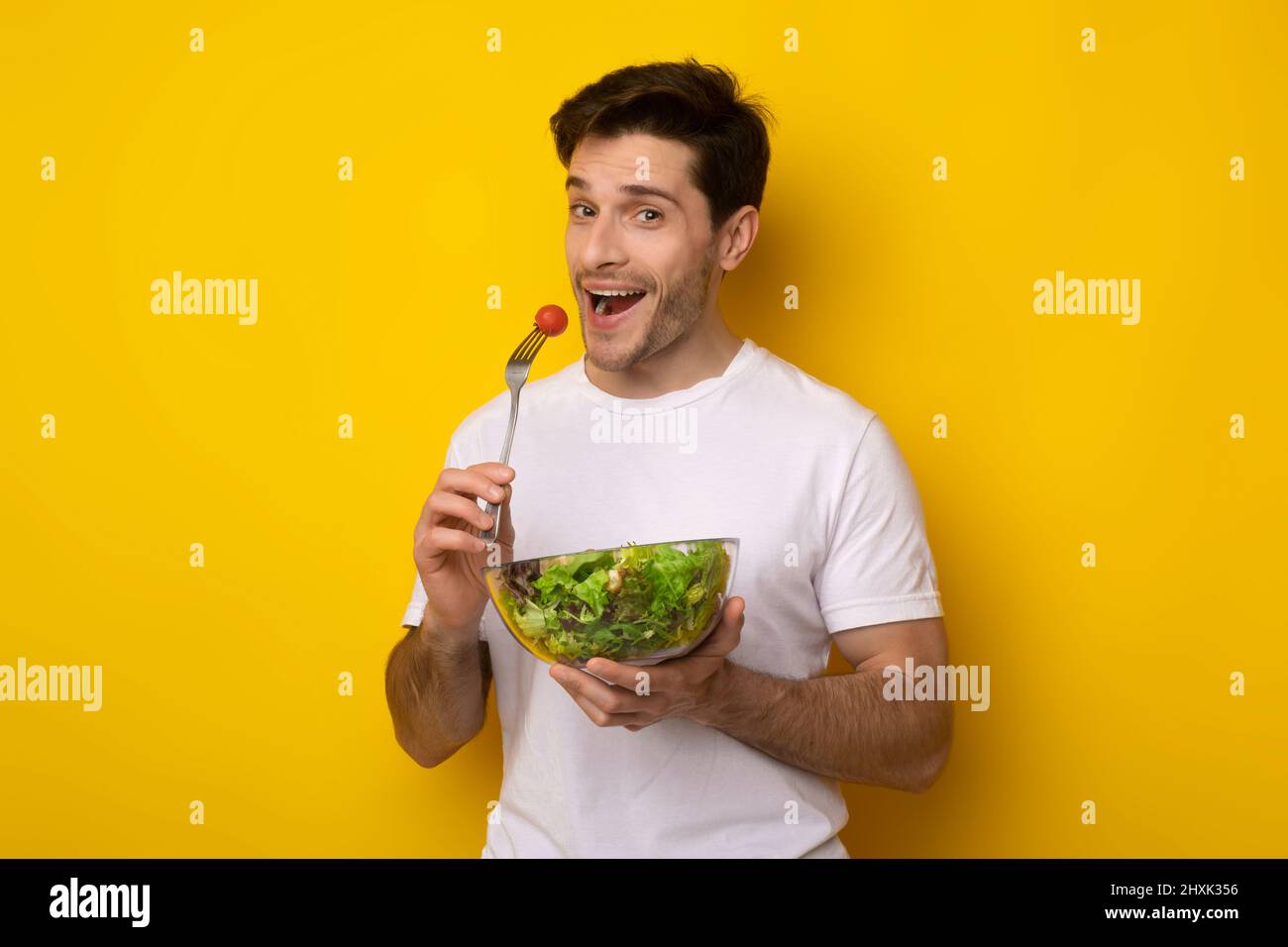 Portrait of Smiling Guy Holding Bowl With Salad Stock Photo - Alamy
