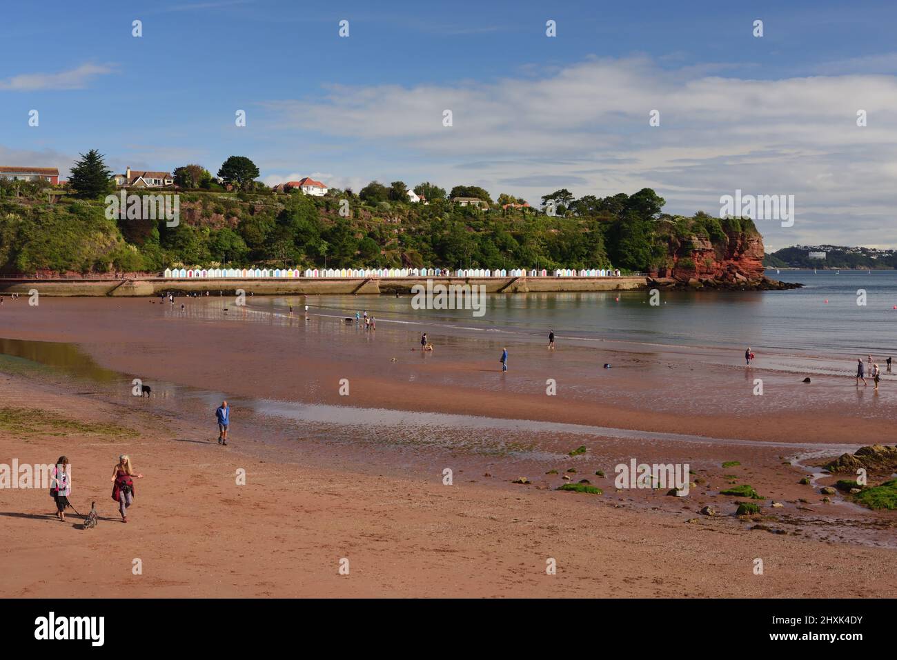 People on the beach at Goodrington Sands, and beach huts below Roundham ...