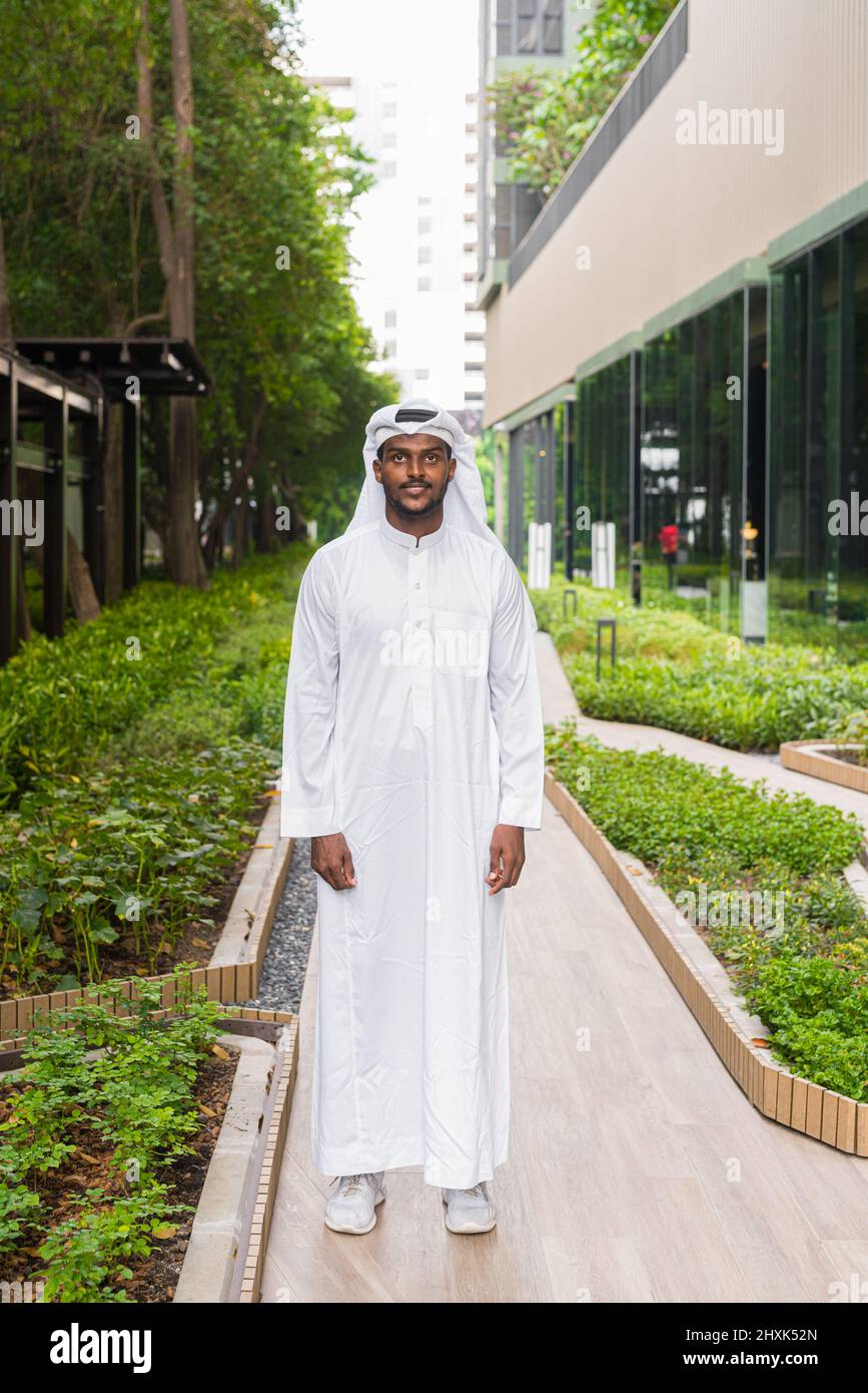 Portrait of young African Muslim man wearing religious clothing an ...