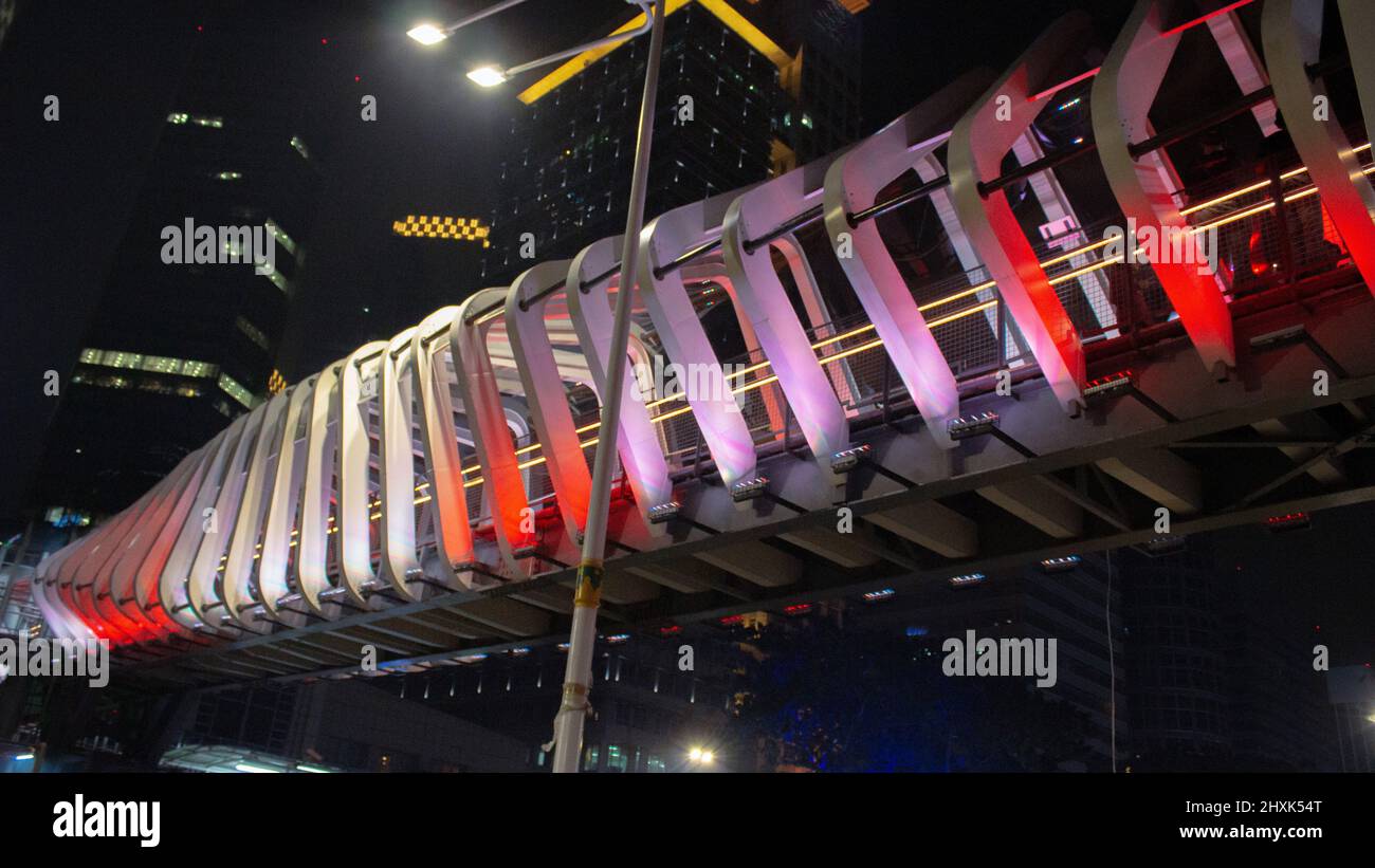 The pedestrian bridge is decorated with colorful neon lights and comes ...