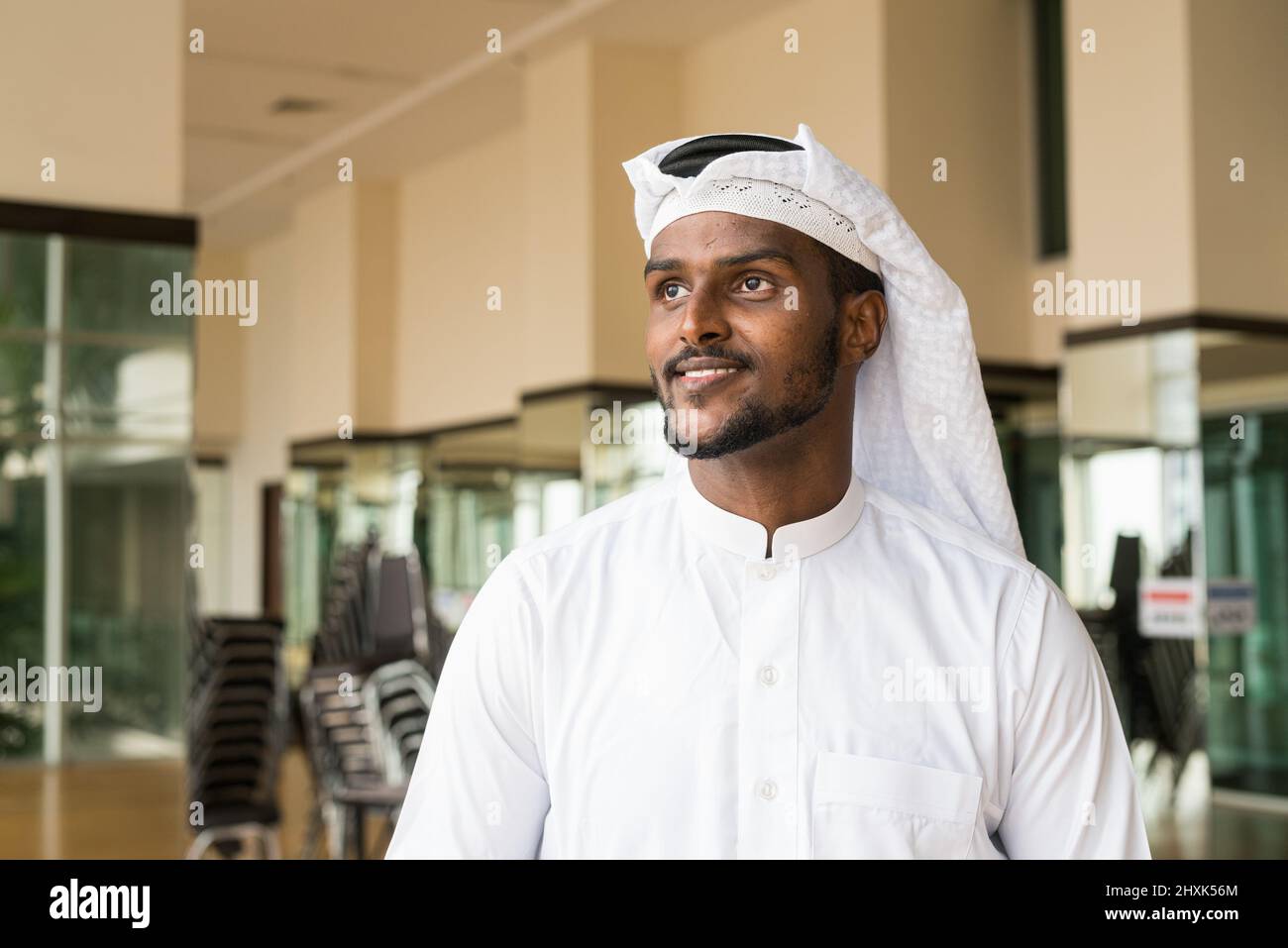 Portrait of young African Muslim man wearing religious clothing an ...