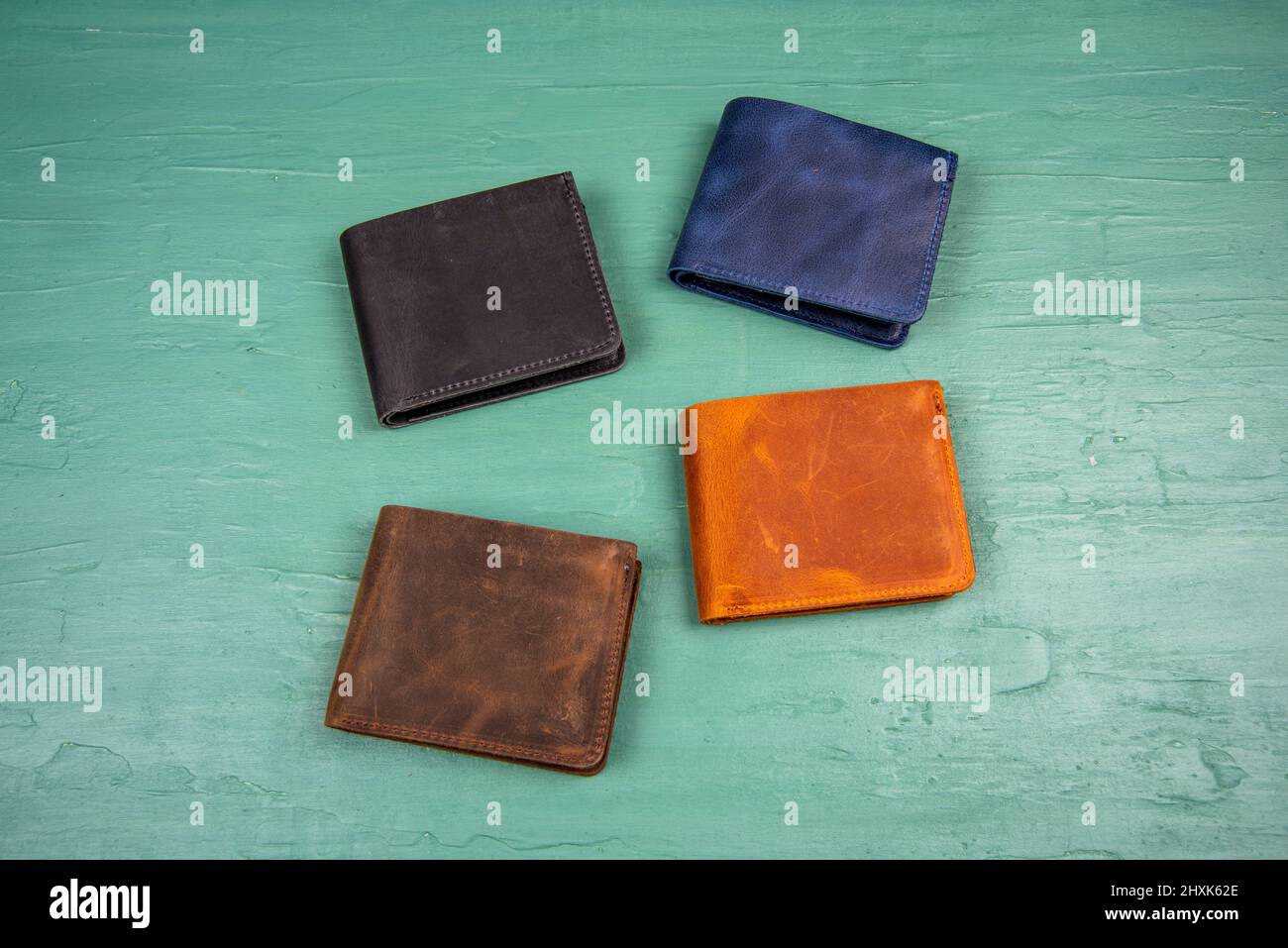 colorful handmade leather wallets on green table men style fashion ...