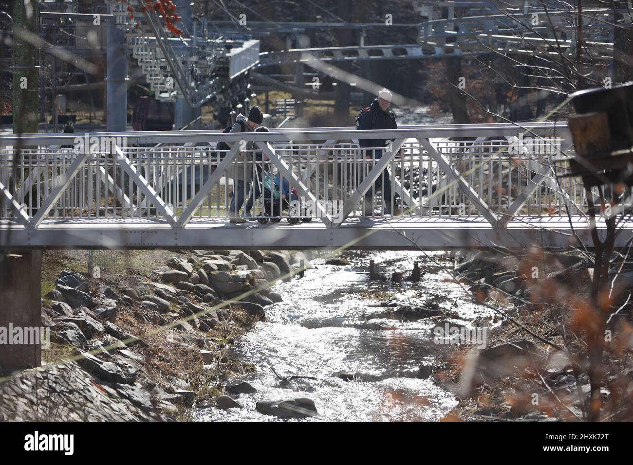 Thale, Germany. 13th Mar, 2022. Visitors walk on a bridge over the Bode ...