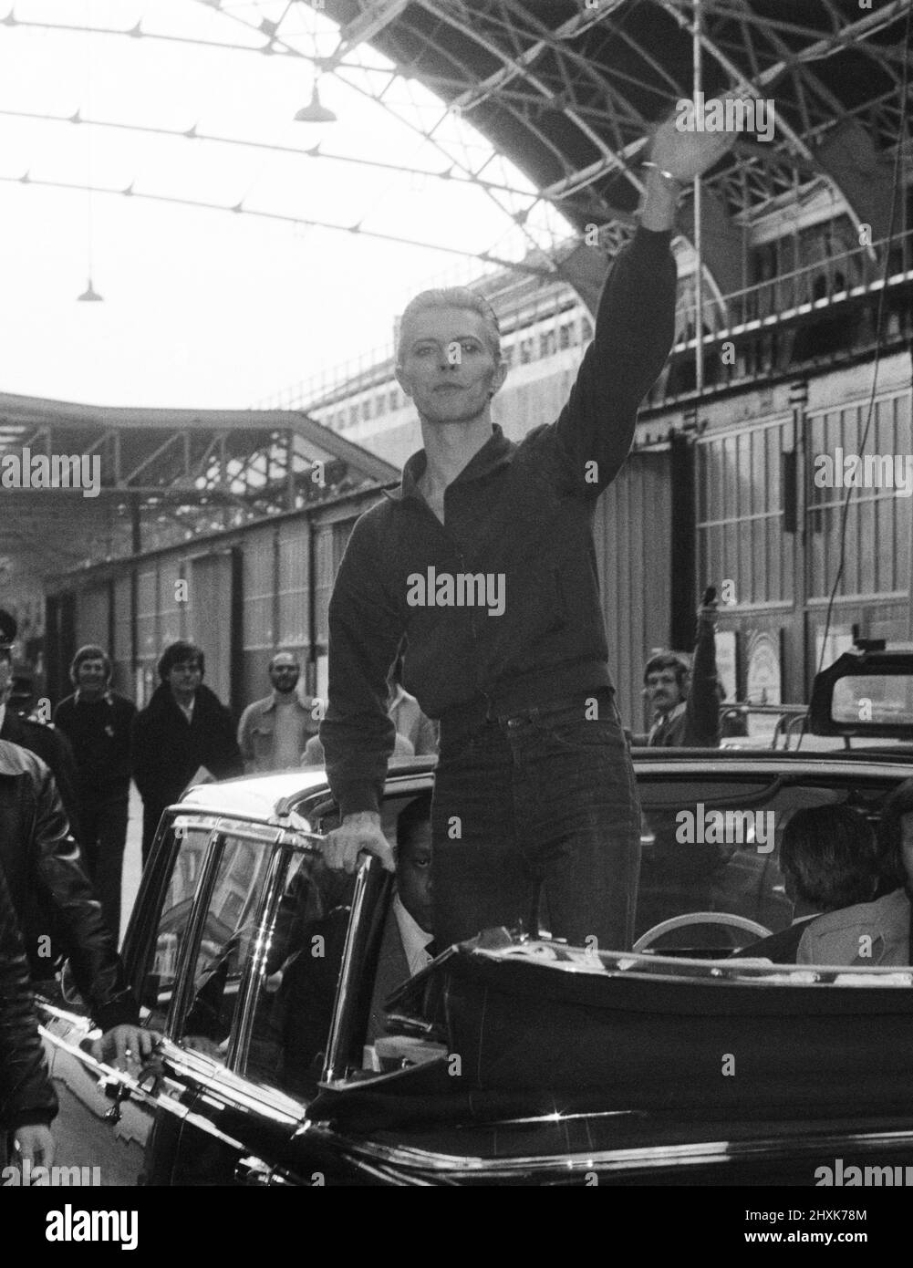 Pop singer David Bowie waves to fans as he arrives at Victoria Station ...