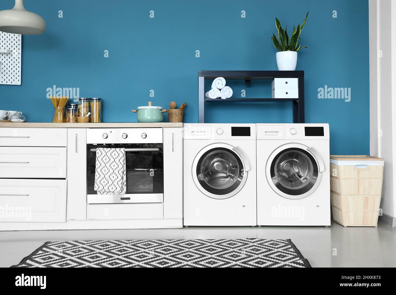 Interior of stylish kitchen with modern washing machines and oven Stock ...
