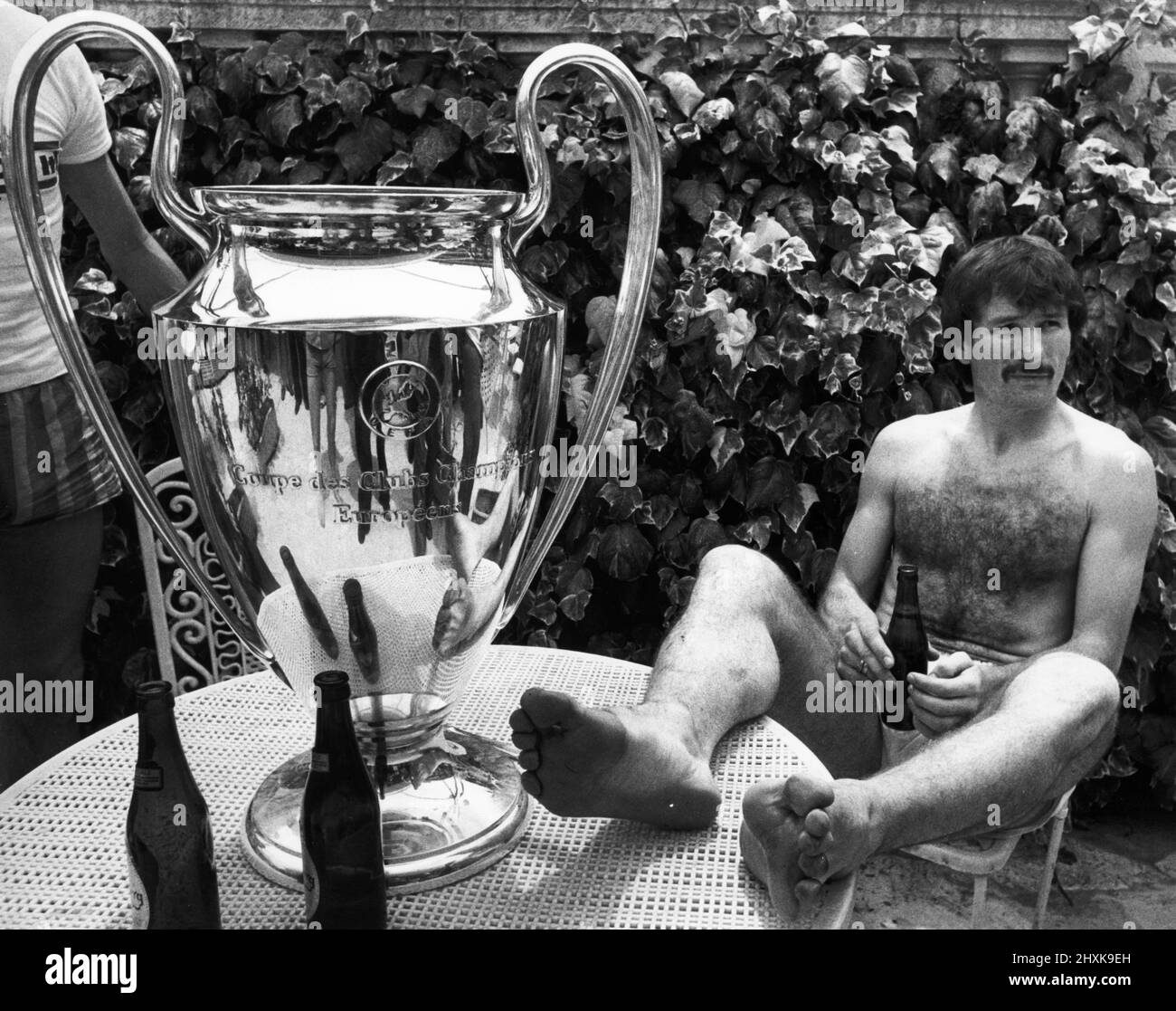 Liverpool footballer Tonny Smith enjoys a bottle of beer as he sits ...