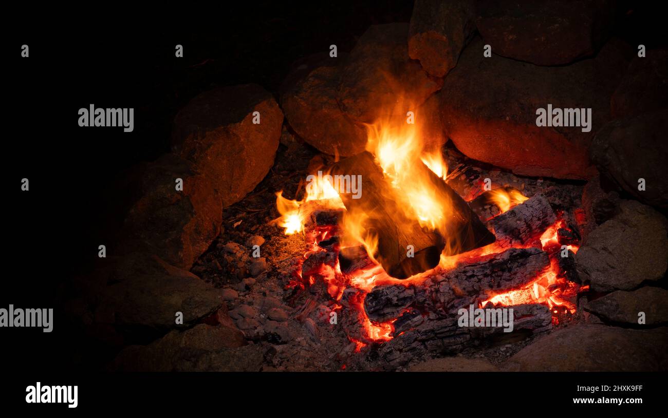 Night campfire burning with rocks in a circle around Stock Photo - Alamy