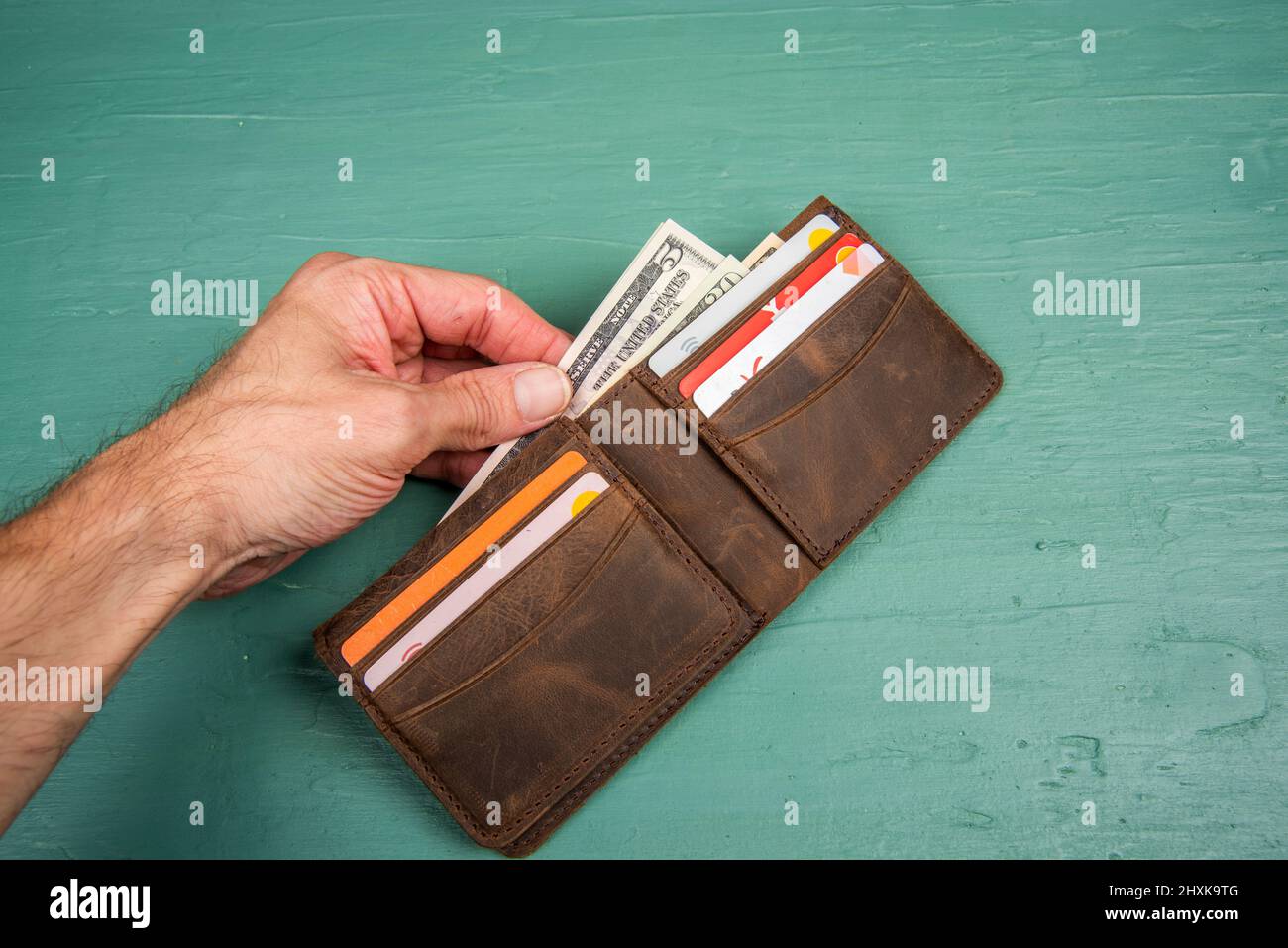 handmade men style leather wallet open and picking us dollars Stock ...